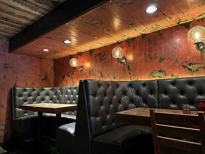 Leather booths, weathered wood, and ambient lighting create dining nooks that invite long conversations and just one more round.