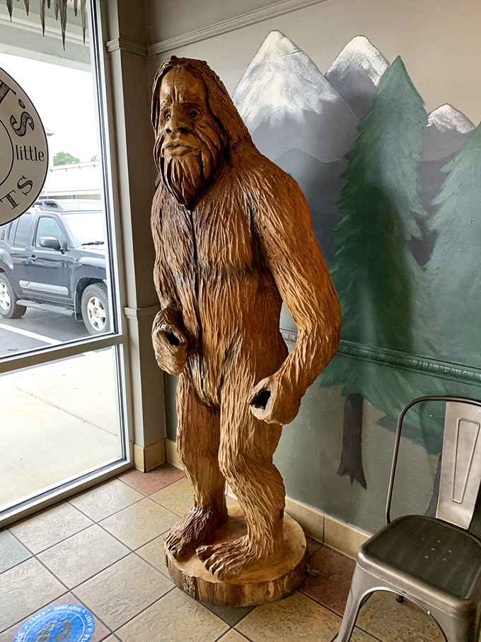 The elusive Bigfoot, caught mid-snack! This wooden statue is the closest you'll get to spotting the real deal (we think).