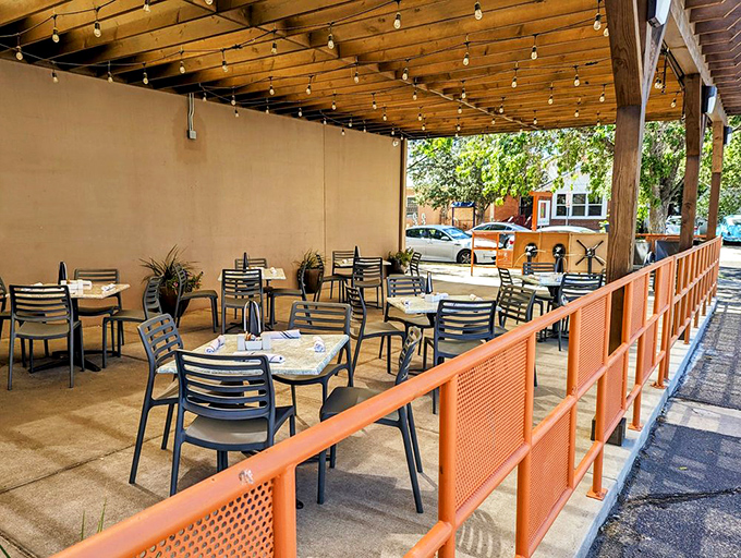 The outdoor patio, where desert breezes and comfort food collide. Those orange dividers aren't just decorative—they're the frame for food memories.