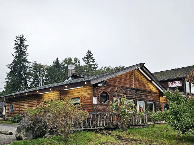 Rustic charm with a side of "Open" sign. This cozy log cabin eatery is ready to welcome hungry travelers and locals alike.