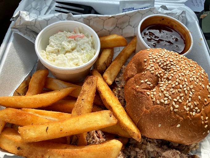 Pulled pork perfection! This sandwich is piled so high, you might need to unhinge your jaw like a snake. But trust us, it's worth it.