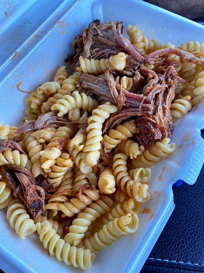 Mac 'n' cheese gets a smoky makeover with pulled pork. It's like comfort food went to finishing school and came back cooler.