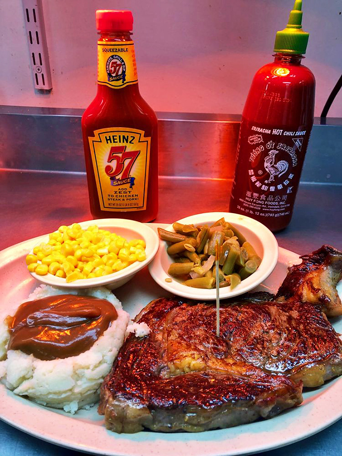 The ribeye speaks the universal language of "perfectly cooked." With classic sides and two sauce options, it's steak night done right.