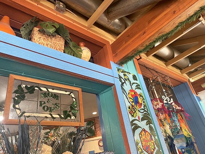 Whimsical wall art featuring the Mom & Pop's logo&mdash;where tropical vibes meet breakfast dreams in a glass-framed paradise.