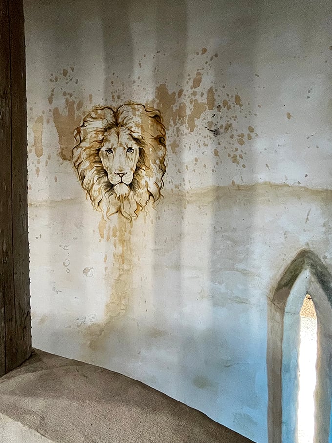 Who let the lions out? This regal feline seems to emerge from the very walls, keeping a watchful eye on visitors.