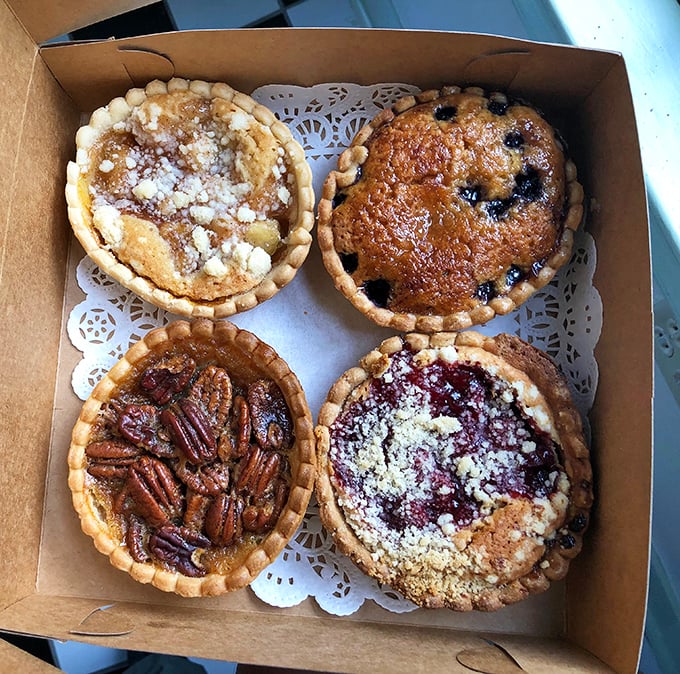 Assorted tarts that are basically edible art. If Bob Ross painted desserts, this is what they'd look like &ndash; happy little tarts!