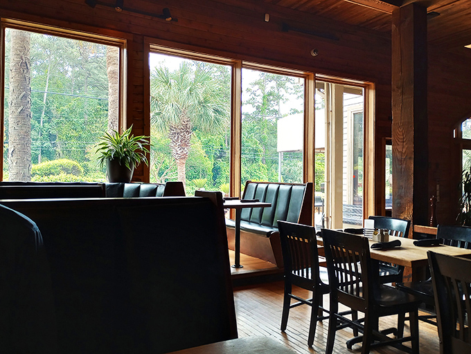 Sunlight streams through expansive windows, warming the polished wood interior where conversations and meals unfold at a refreshingly unhurried pace.