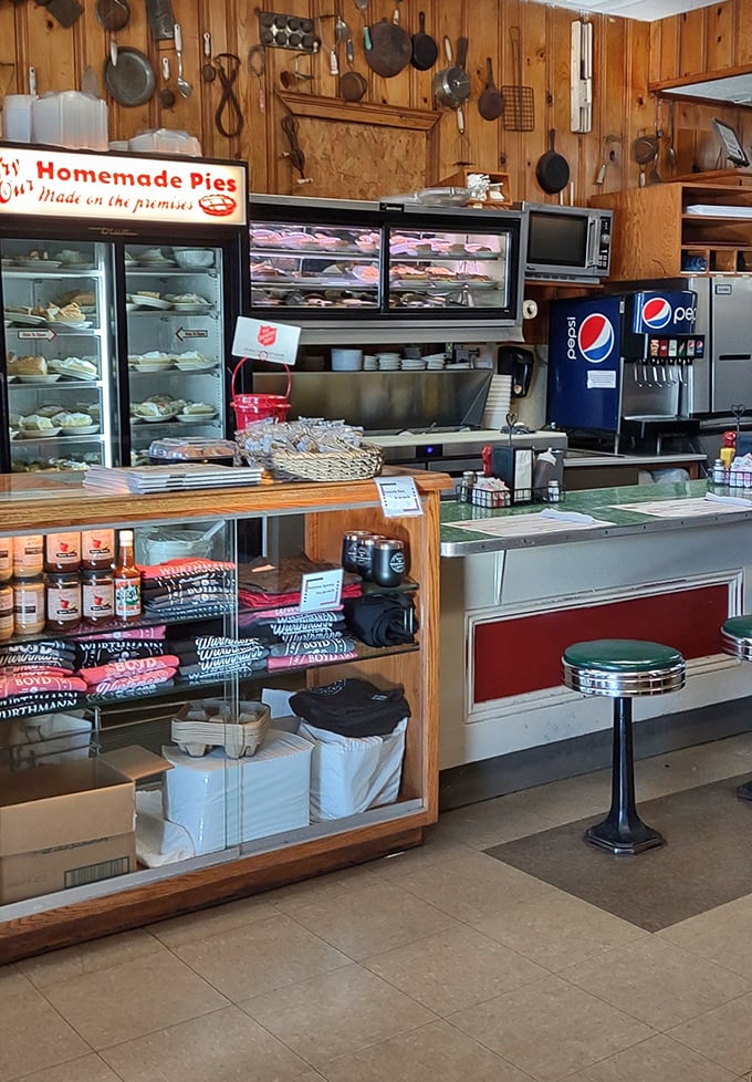 The counter area reveals the restaurant's grocery store origins, where vintage cooking tools hang like museum pieces and pies wait patiently for their admirers.