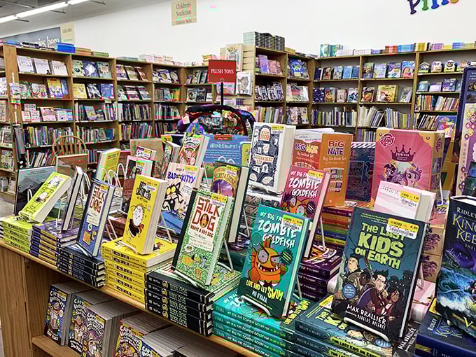 The kids' section: where young minds bloom and parents' wallets wilt. But hey, at least it's quieter than a theme park!