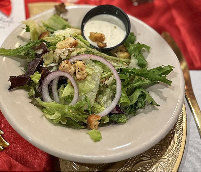 Even the house salad gets the VIP treatment with crisp greens, purple onion rings, and housemade croutons&mdash;proof that sidekicks can steal scenes too.