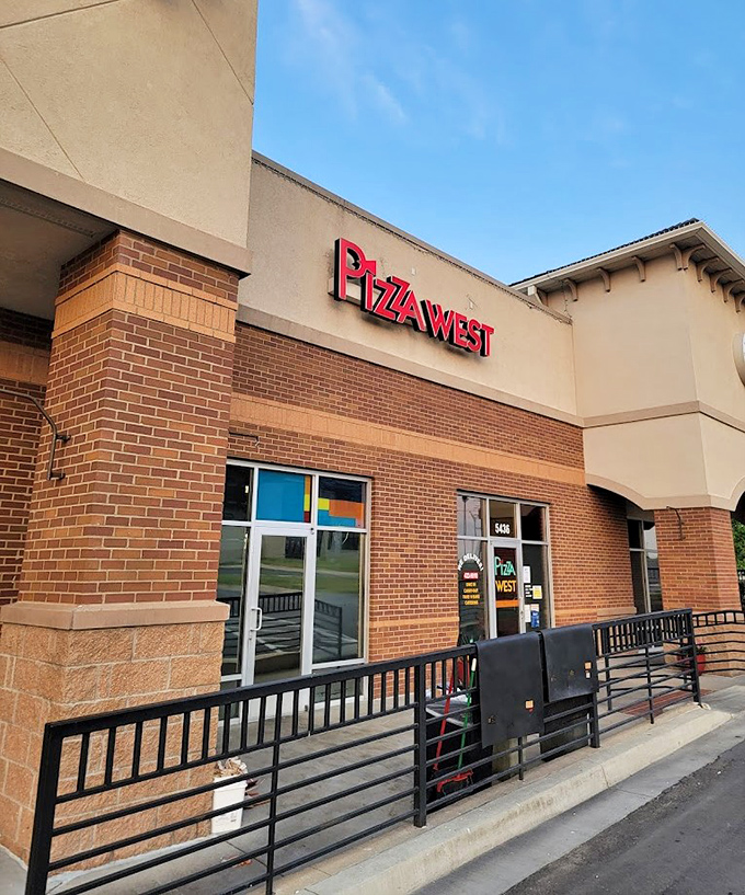 The clean lines of Pizza West's exterior hide a world where the phrase "I'll just have one slice" goes to die.