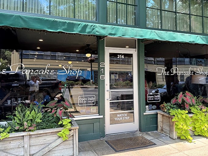 The iconic green awning and vintage sign of The Pancake Shop stands as a breakfast beacon on Hot Springs' Central Avenue, promising morning magic within.