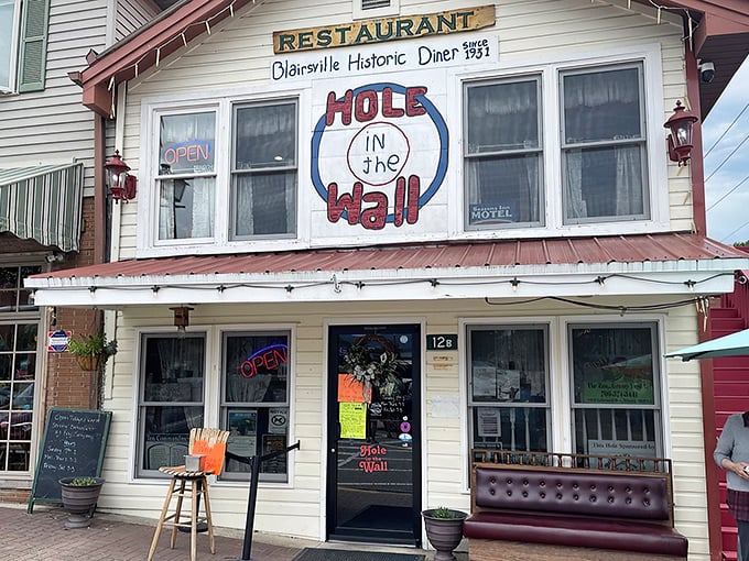 The unassuming exterior of Hole In The Wall beckons like an old friend, promising comfort and satisfaction behind that screen door.