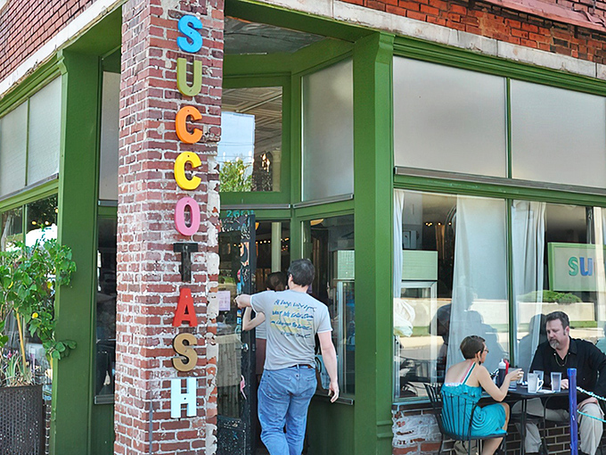 The iconic brick facade of Succotash welcomes hungry souls with its vintage vertical signage and promise of comfort food extraordinaire. 