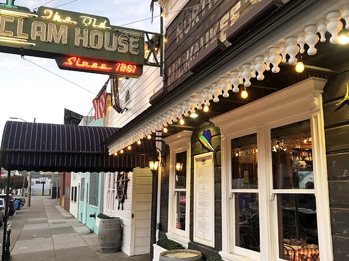 Twilight transforms this 1861 seafood sanctuary into a maritime mirage. The vintage neon sign beckons hungry travelers like a lighthouse for the famished.
