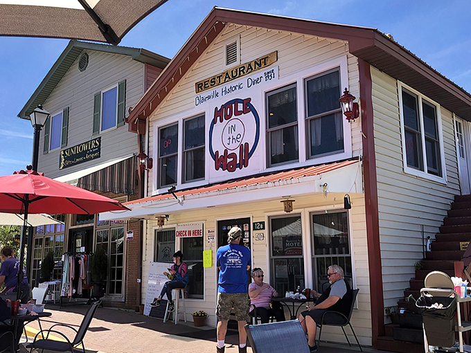 The unassuming exterior of Hole In The Wall beckons like an old friend, promising comfort and satisfaction behind that screen door.