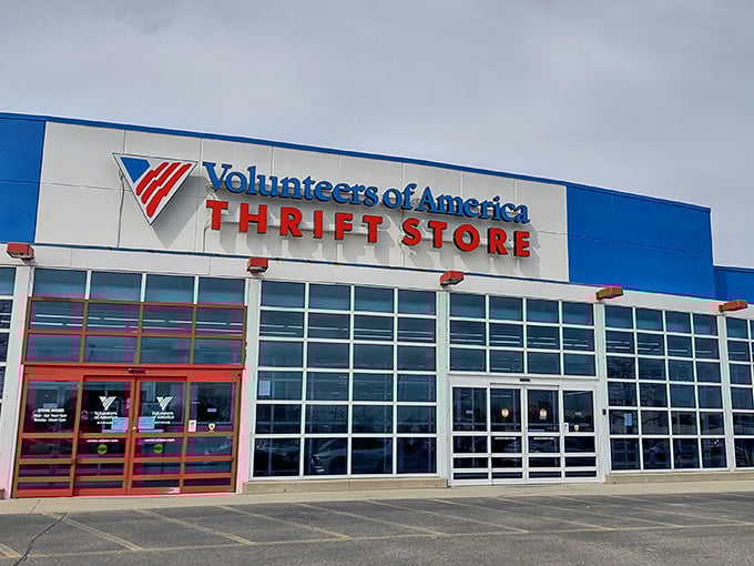 The blue and white exterior stands like a retail fortress of possibility, promising treasure hunts behind those bold red doors.