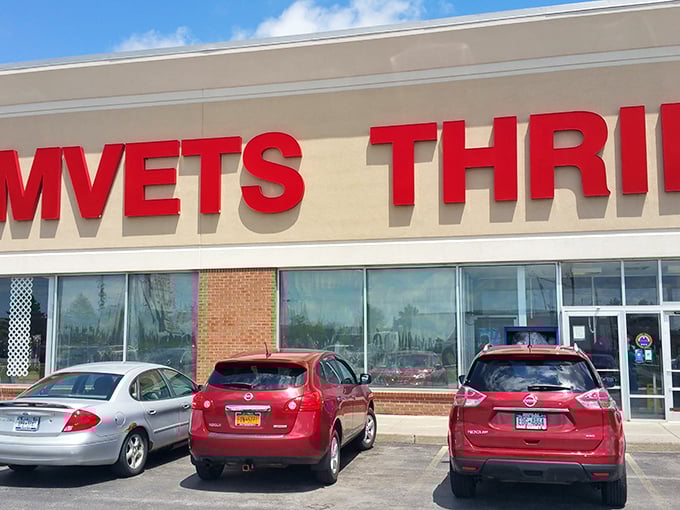 The bright red letters of AMVETS Thrift call to bargain hunters like a beacon, promising treasures waiting just beyond those doors.