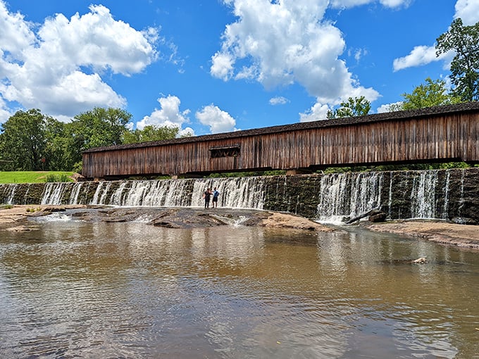 Mother Nature showing off her architectural collaboration with humans. The historic covered bridge spans across cascading waters like a postcard come to life.