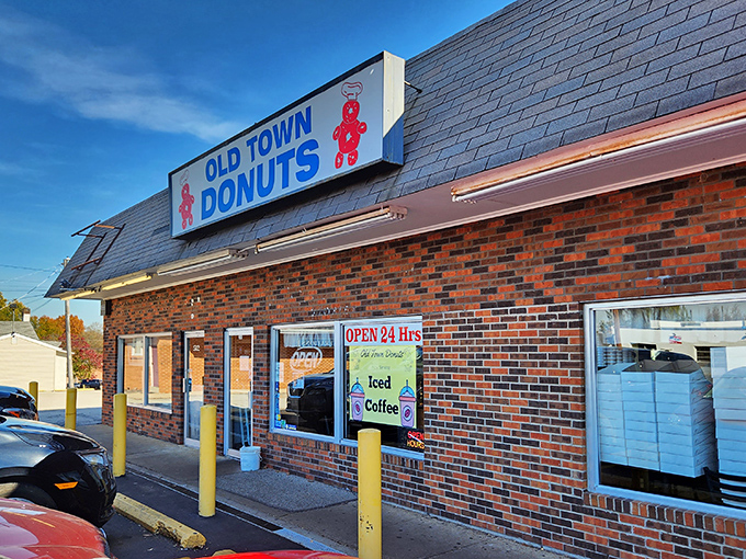 The legendary yellow hand with pink donut - Old Town Donuts' iconic mascot welcoming sugar-seekers 24/7. It's like the Statue of Liberty for the sweet-toothed.