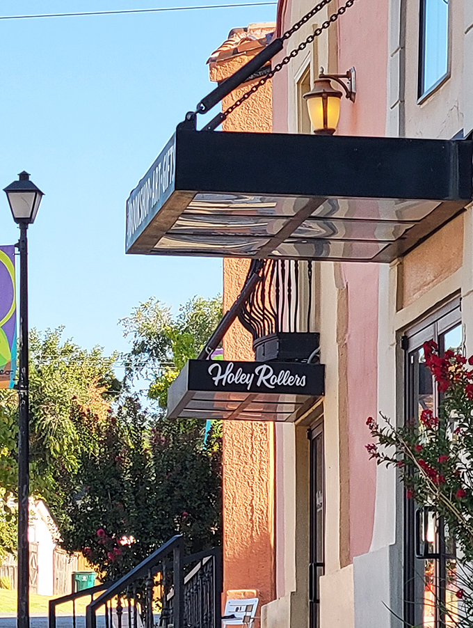 The peachy façade of Holey Rollers stands like a sweet beacon in OKC's Paseo Arts District, promising delicious revelations within those glass doors.