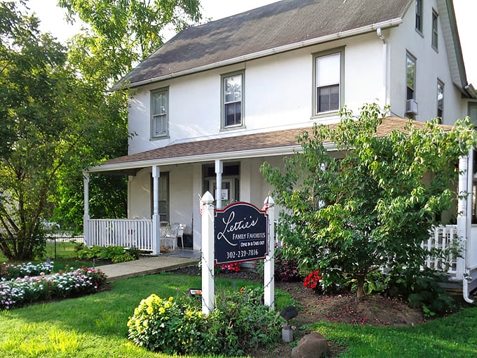The white farmhouse exterior of Lettie's Kitchen stands like a culinary beacon in Hockessin, promising comfort food that transcends the ordinary.