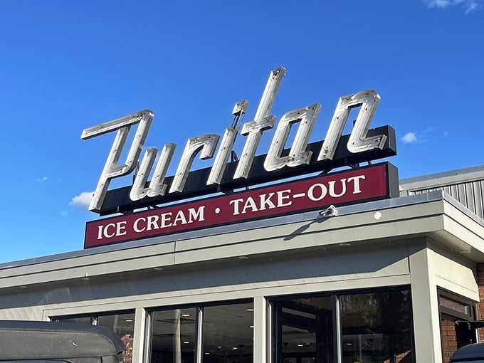 The iconic Puritan sign beckons like an old friend, promising ice cream and take-out treasures that have made Manchester residents swoon for generations.
