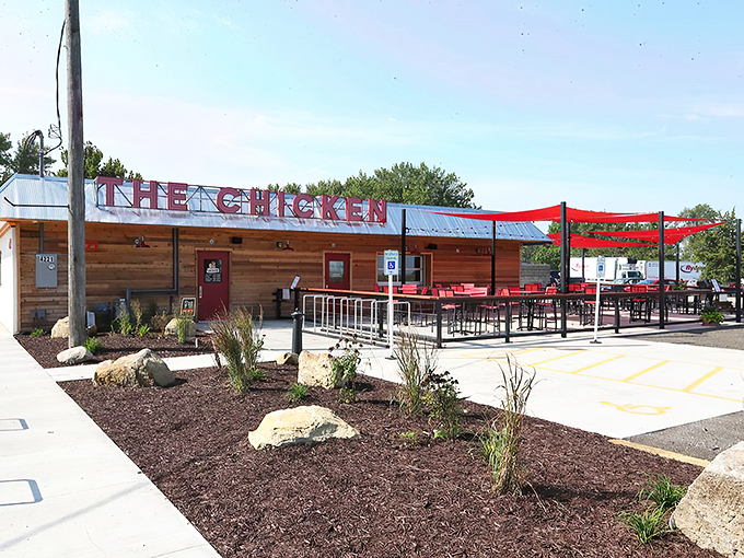 The rustic wooden exterior with those eye-catching red shade sails isn't just inviting&mdash;it's practically shouting "Come get some chicken that'll change your life!"
