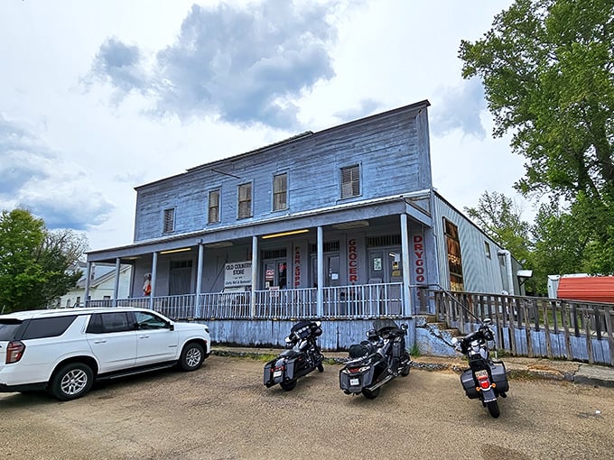 The weathered clapboard exterior of The Old Country Store stands as a time capsule from the 1800s, beckoning hungry travelers with rustic charm. 