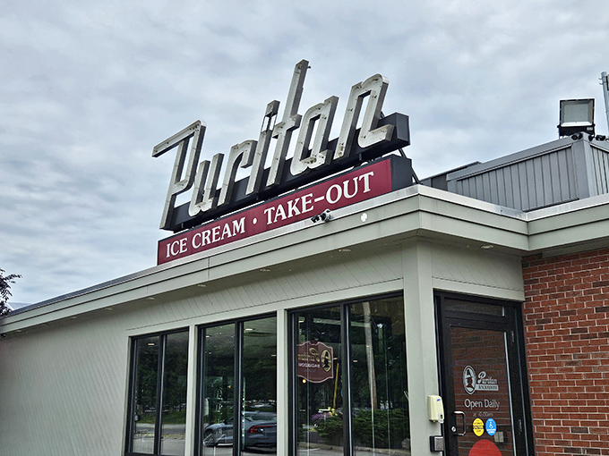 The iconic Puritan sign beckons like an old friend, promising ice cream and take-out treasures that have made Manchester residents swoon for generations.