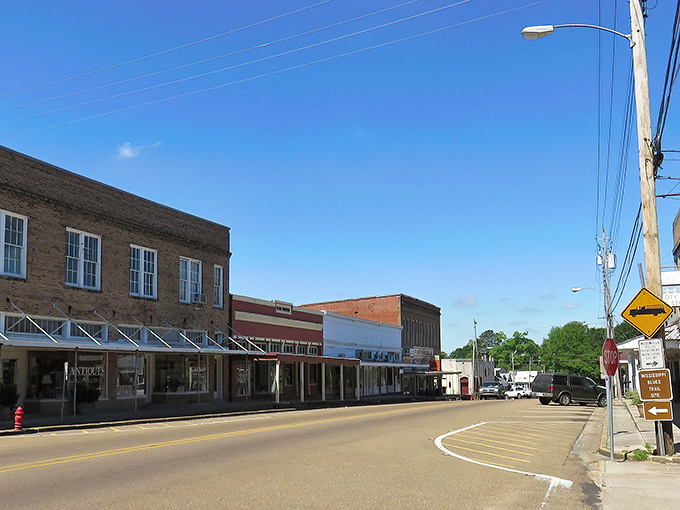 Woodville's historic Main Street welcomes visitors with its timeless charm, where brick buildings and covered walkways tell stories of Mississippi's past.