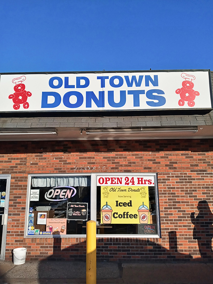 The legendary yellow hand with pink donut - Old Town Donuts' iconic mascot welcoming sugar-seekers 24/7. It's like the Statue of Liberty for the sweet-toothed.