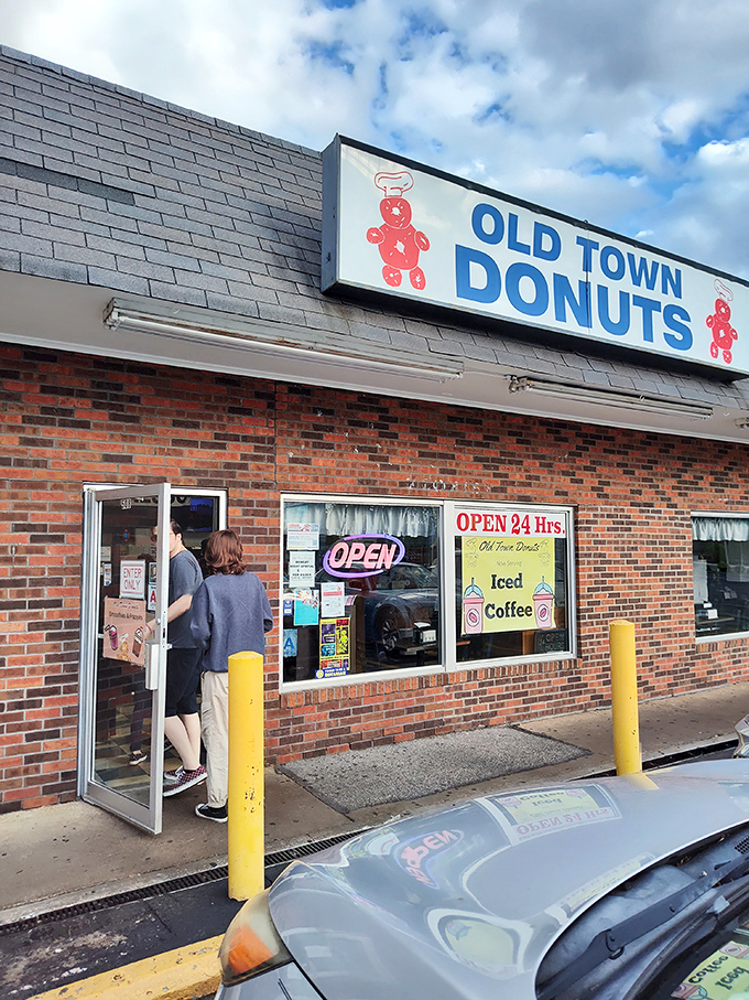 The legendary yellow hand with pink donut - Old Town Donuts' iconic mascot welcoming sugar-seekers 24/7. It's like the Statue of Liberty for the sweet-toothed.