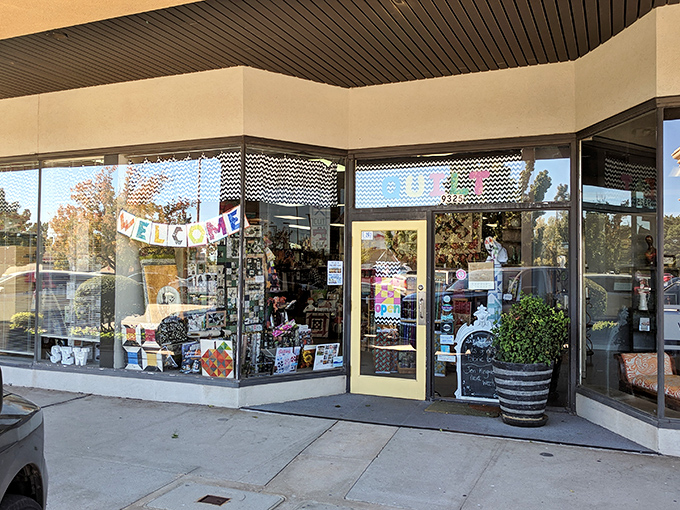 The sunny yellow door of Oklahoma Quiltworks beckons fabric enthusiasts like a textile Bat-Signal. Creative adventures await inside this unassuming storefront.