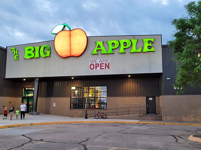The iconic red apple sign beckons fun-seekers like a beacon of joy amid the Nebraska plains. Entertainment paradise awaits inside!