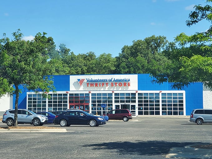 The blue and white exterior stands like a retail fortress of possibility, promising treasure hunts behind those bold red doors.