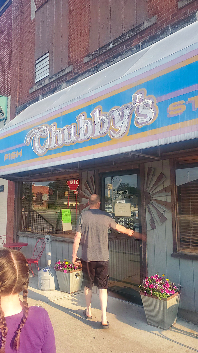 The iconic blue and pink awning of Chubby's beckons like a beacon to hungry travelers. Small-town charm with big-time flavor credentials.