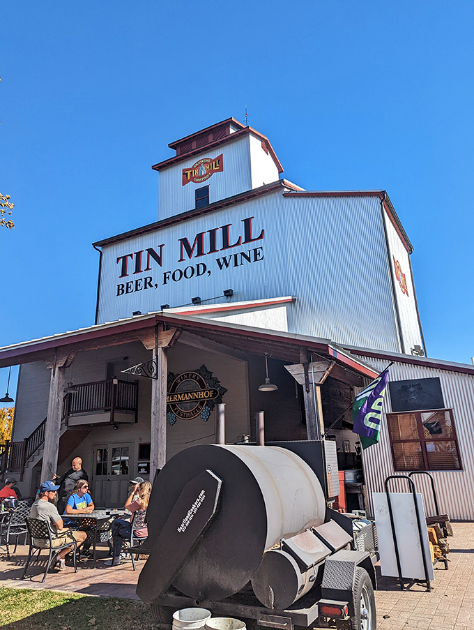 The iconic white exterior of Tin Mill Restaurant stands tall against the Missouri sky, promising German-American delights inside this converted historic building.
