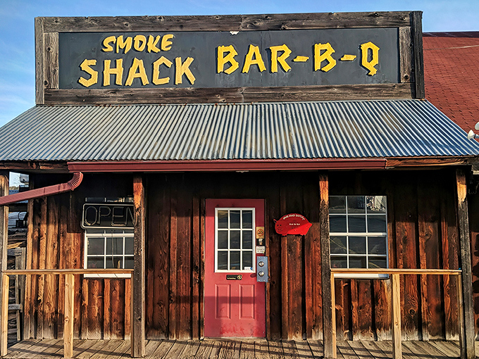 That hand-painted yellow sign against weathered wood isn't just decoration&mdash;it's a promise of smoky delights waiting behind that bright red door.