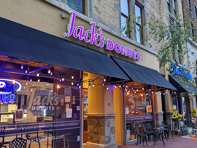 Jack's Donuts announces its presence with charming simplicity—a yellow brick building, black awning, and the promise of sweet satisfaction waiting inside.