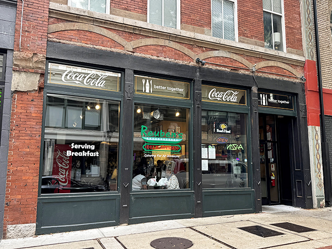 The historic brick fa&ccedil;ade of Reuben's Deli stands as a beacon for sandwich aficionados. That vintage sign promises delicious things await inside.