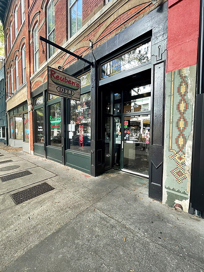 The historic brick fa&ccedil;ade of Reuben's Deli stands as a beacon for sandwich aficionados. That vintage sign promises delicious things await inside.