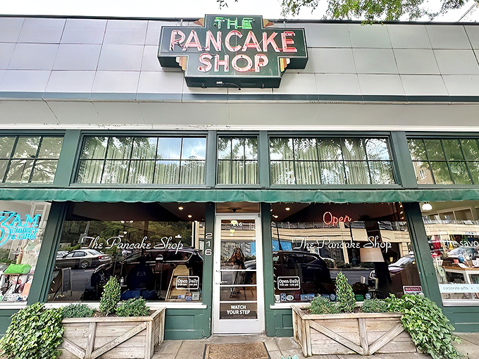 The iconic green awning and vintage sign of The Pancake Shop stands as a breakfast beacon on Hot Springs' Central Avenue, promising morning magic within.