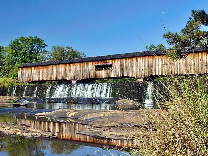 Mother Nature showing off her architectural collaboration with humans. The historic covered bridge spans across cascading waters like a postcard come to life.