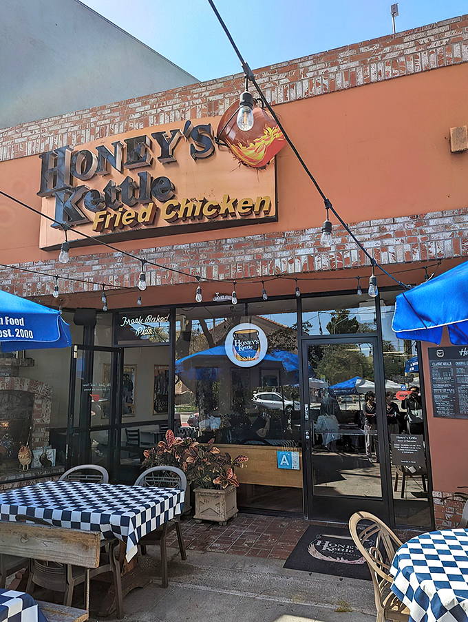 The vibrant orange facade of Honey's Kettle beckons like a beacon of fried chicken salvation on a hungry Culver City afternoon.