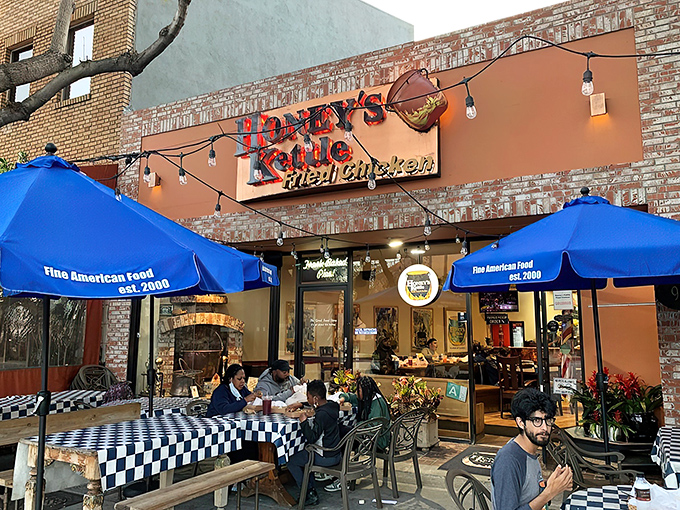 The vibrant orange facade of Honey's Kettle beckons like a beacon of fried chicken salvation on a hungry Culver City afternoon.