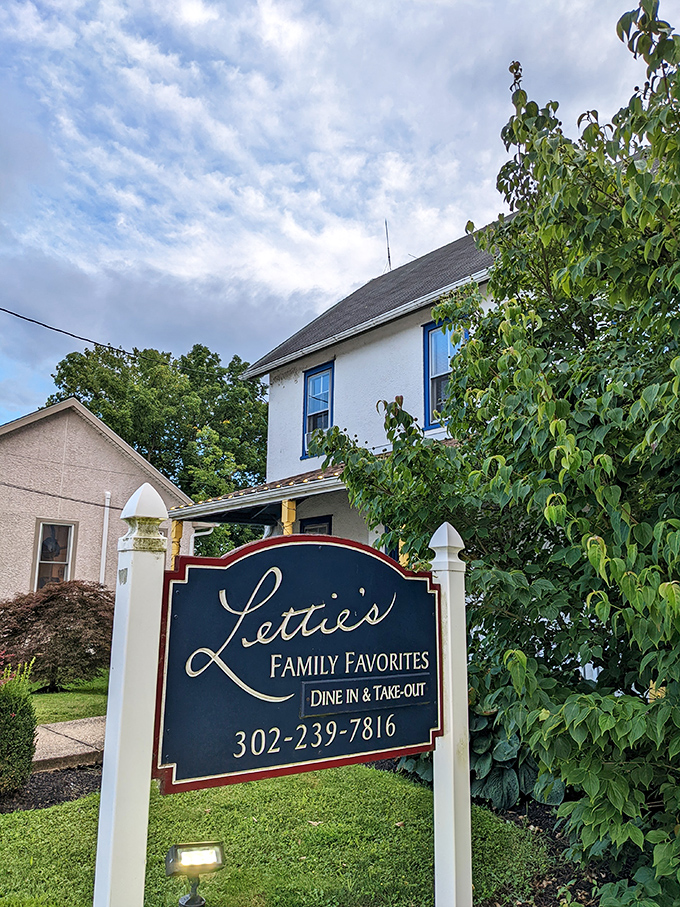 The white farmhouse exterior of Lettie's Kitchen stands like a culinary beacon in Hockessin, promising comfort food that transcends the ordinary.