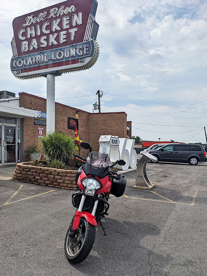The iconic neon sign and Route 66 shield welcome hungry travelers like a beacon of fried chicken salvation.