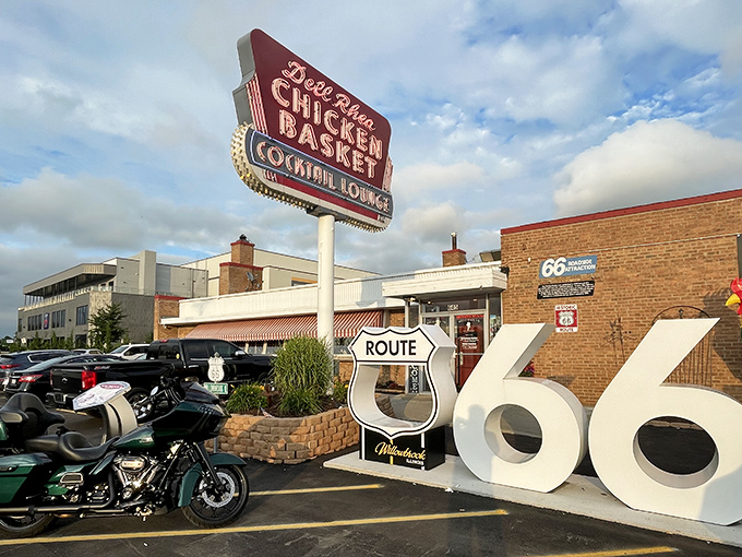 The iconic neon sign and Route 66 shield welcome hungry travelers like a beacon of fried chicken salvation.