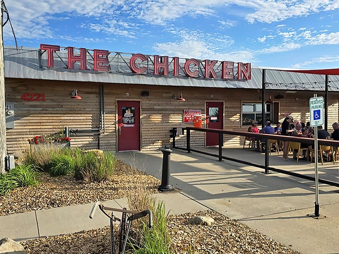 The rustic wooden exterior with those eye-catching red shade sails isn't just inviting&mdash;it's practically shouting "Come get some chicken that'll change your life!"